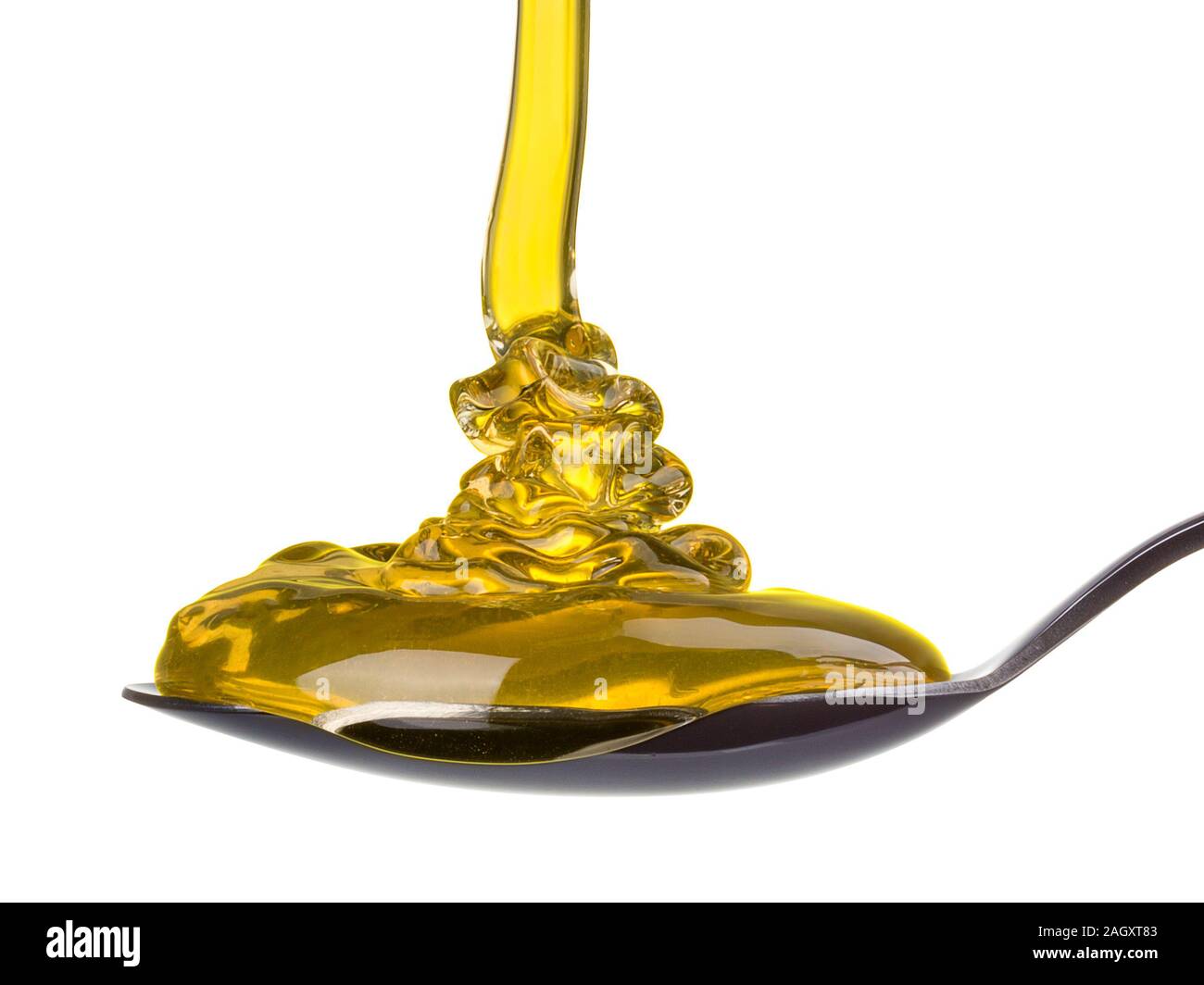 Falling and flowing honey on a spoon isolated on white with clipping ...