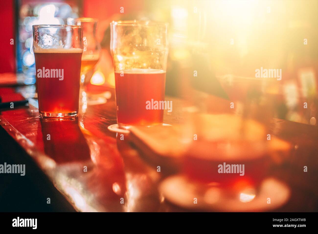 Pair of red ale mugs on a bar counter Stock Photo - Alamy