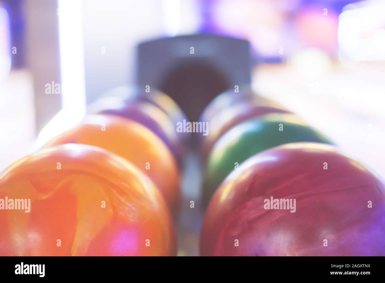 Multicolored bowling balls arranged in a row. Vivid colors. Summer day ...