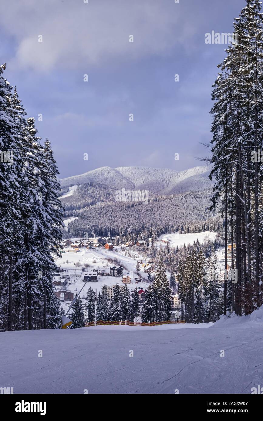 Vertical image with view on Ukrainian mountain village as seen from ski ...