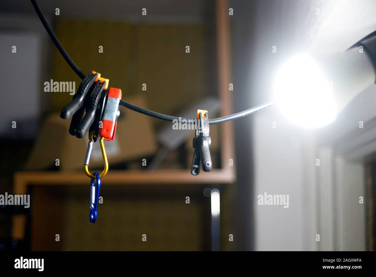Bulb and clamps on the wire in the workshop Stock Photo - Alamy