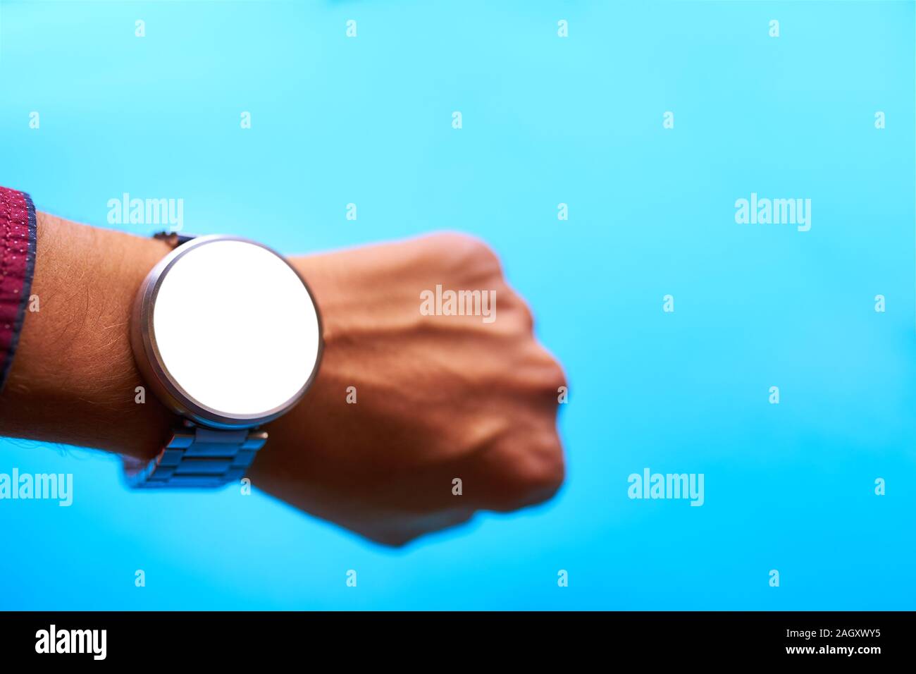 Smart watch on hand on blue background with isolated, blank screen for ...