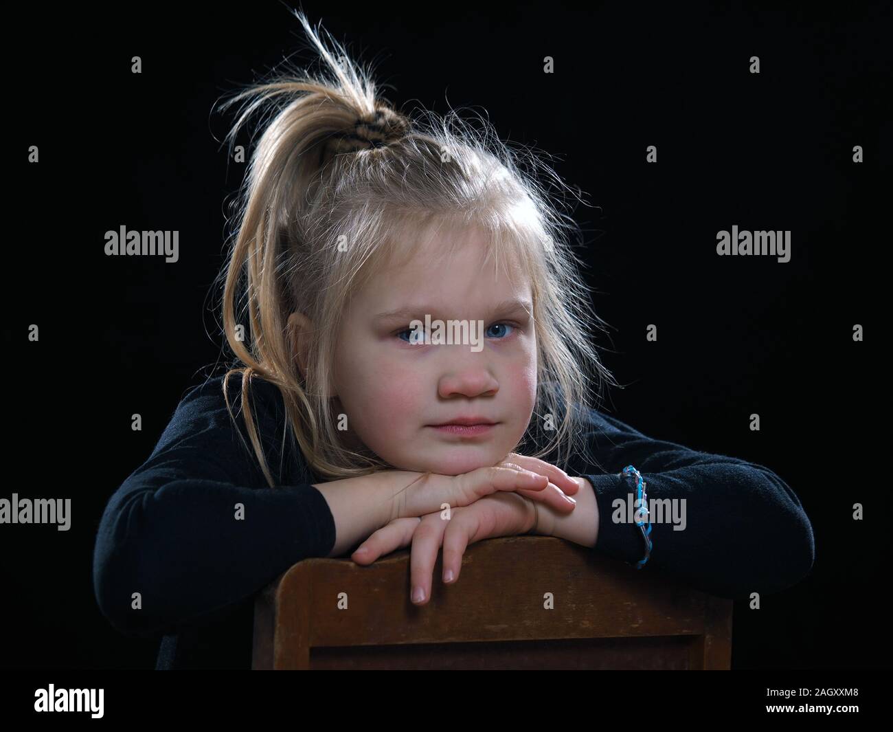 Emotional portrait of a sad girl on a black background Stock Photo - Alamy