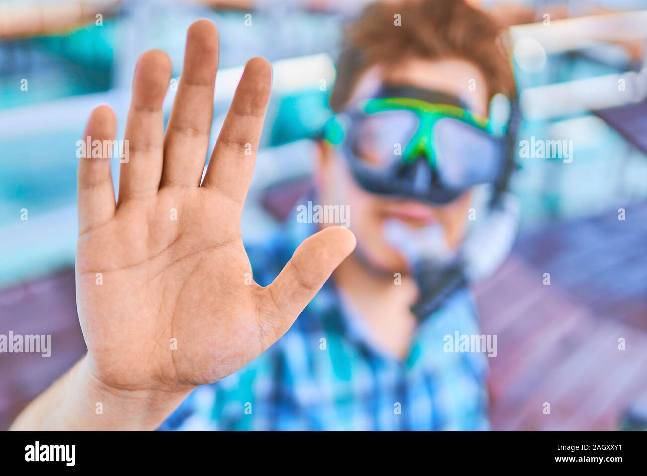 A man in an underwater mask, waving to the camera. Concept of a busy ...