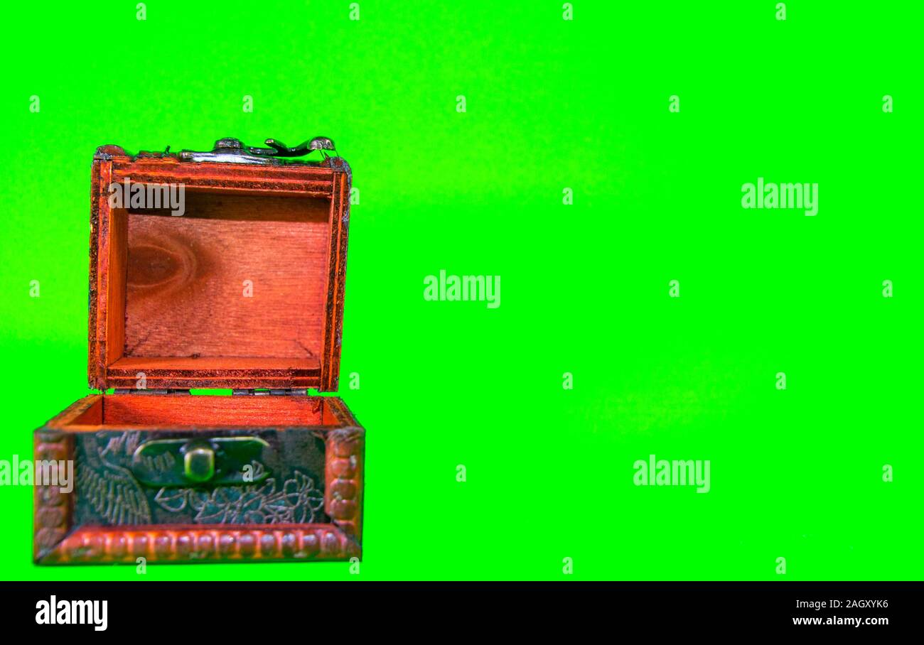 A small toy wooden chest, taken against a bright green screen ...