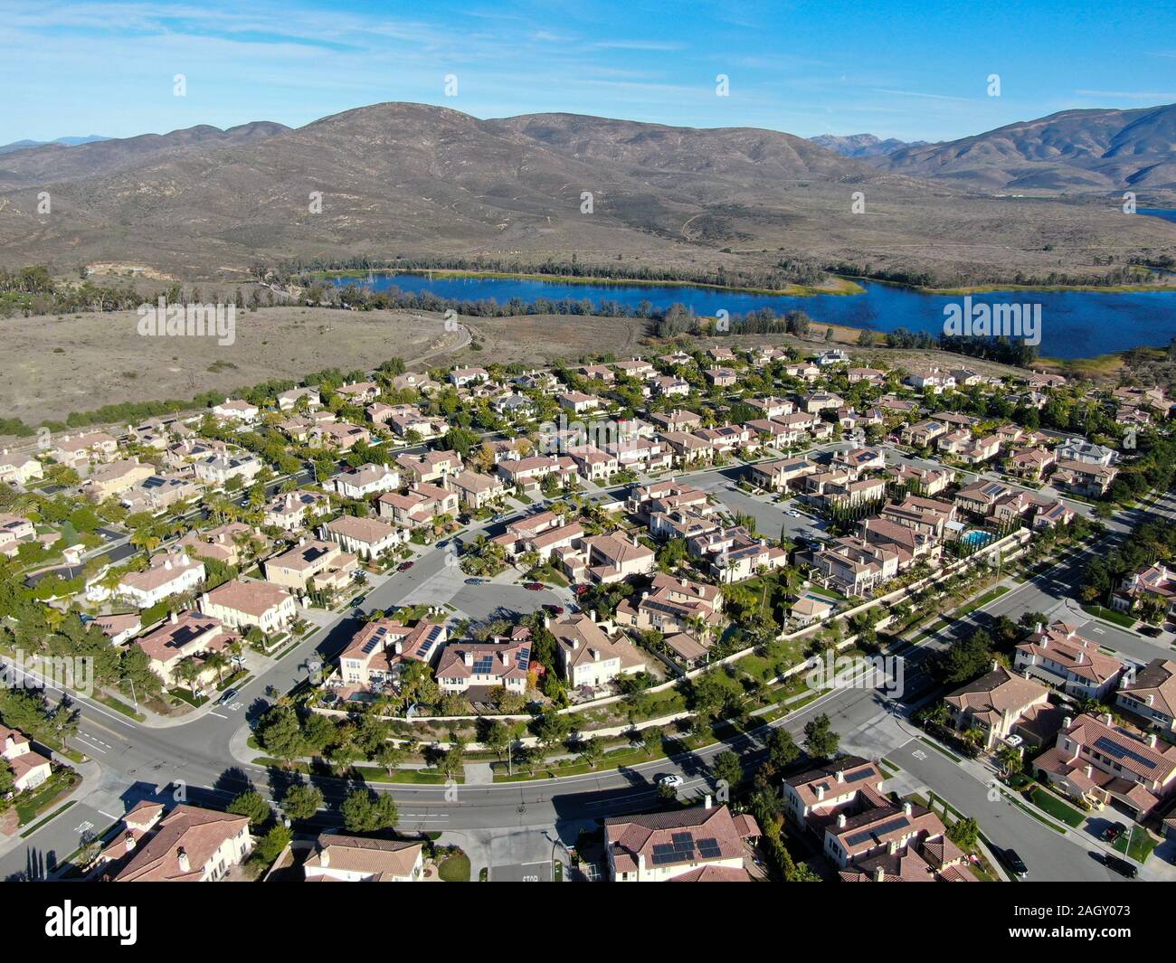 Aerial view of identical residential subdivision house with big lake ...