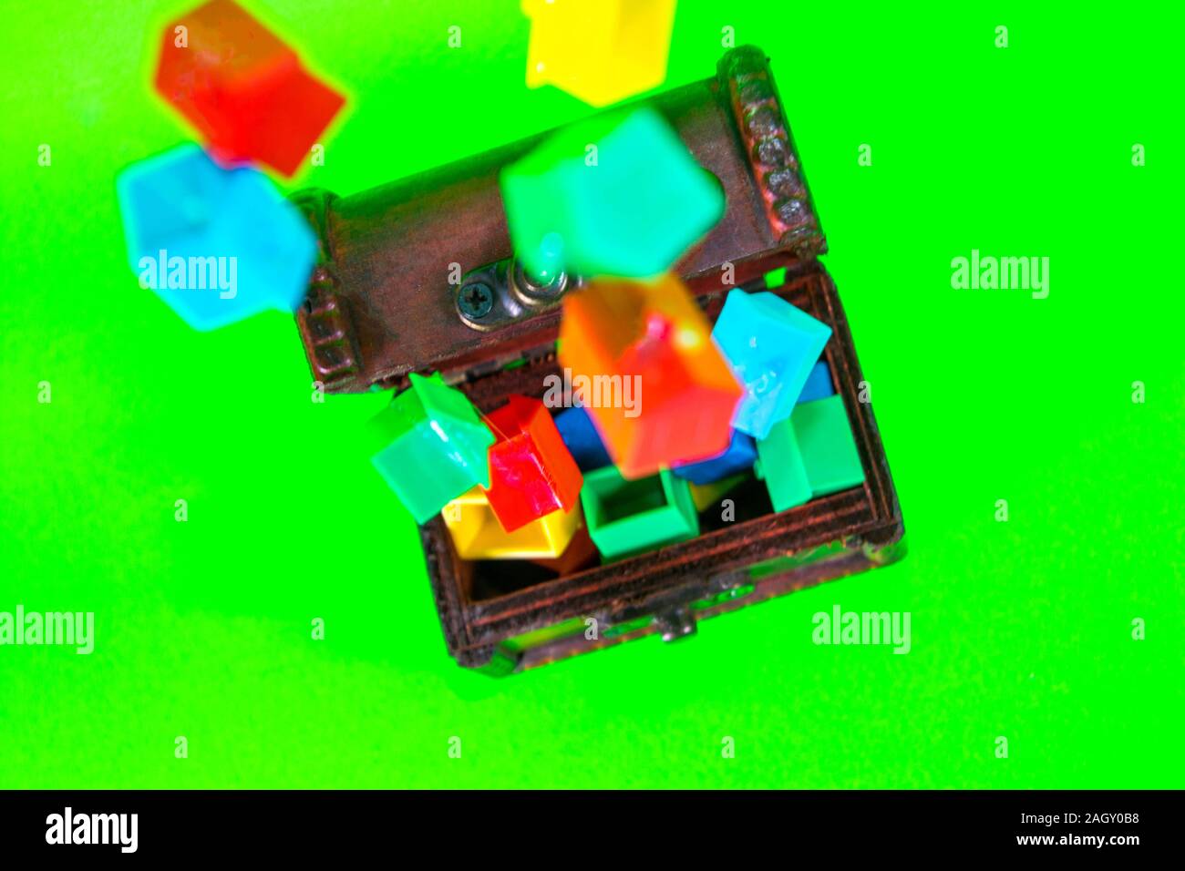 A wooden chest full of plastic houses, taken against a green screen ...