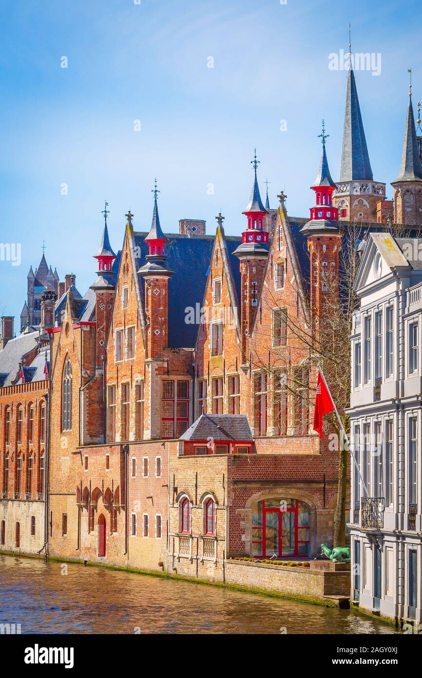 Historic medieval buildings along a canal in Bruges, Belgium Stock ...