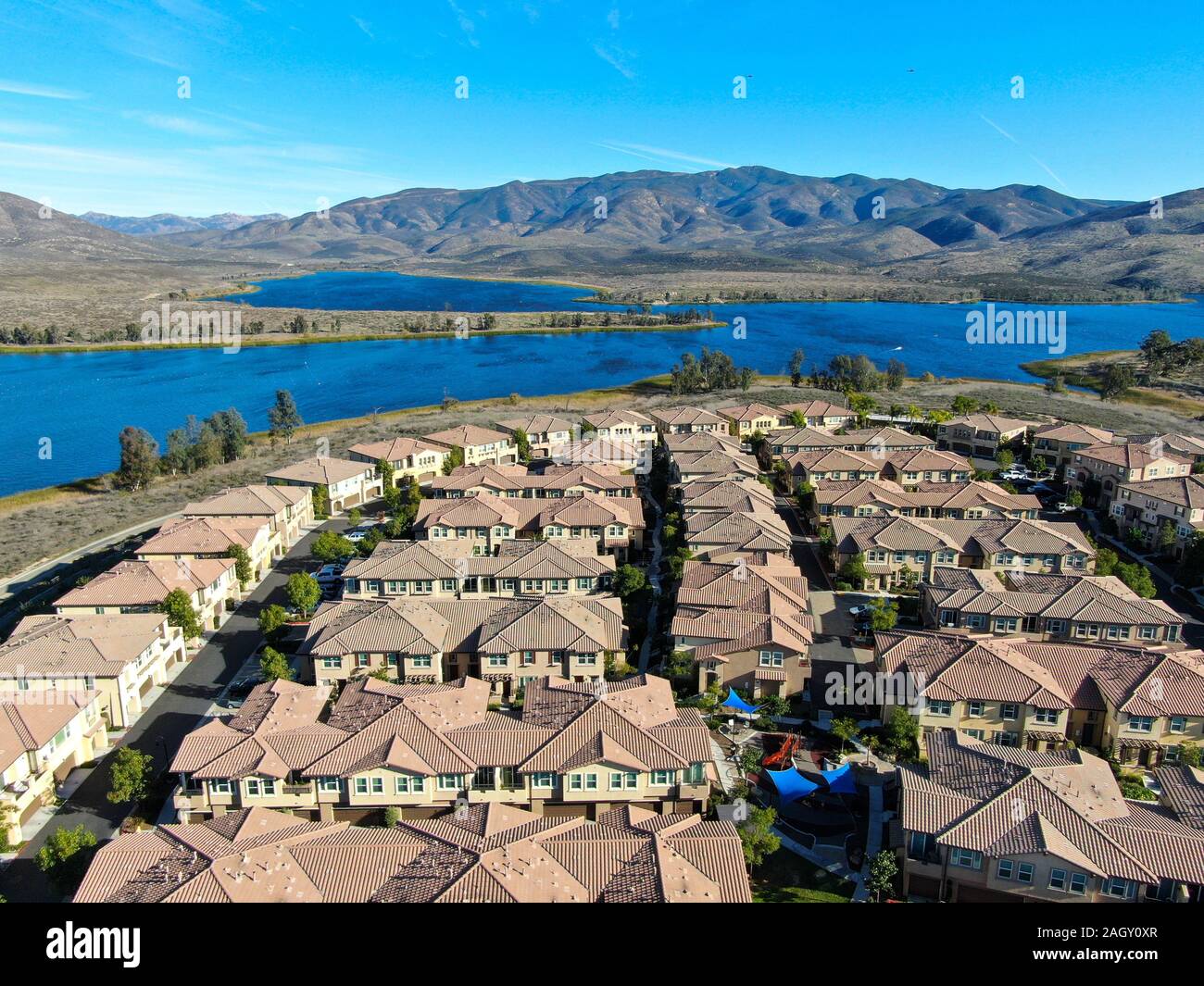 Aerial view of identical residential subdivision house with big lake ...
