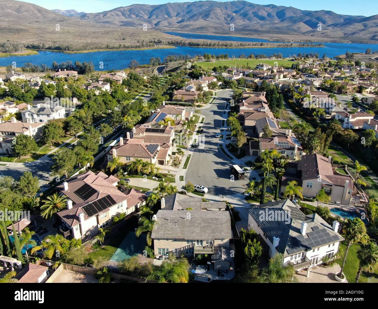 Aerial view of identical residential subdivision house with big lake ...