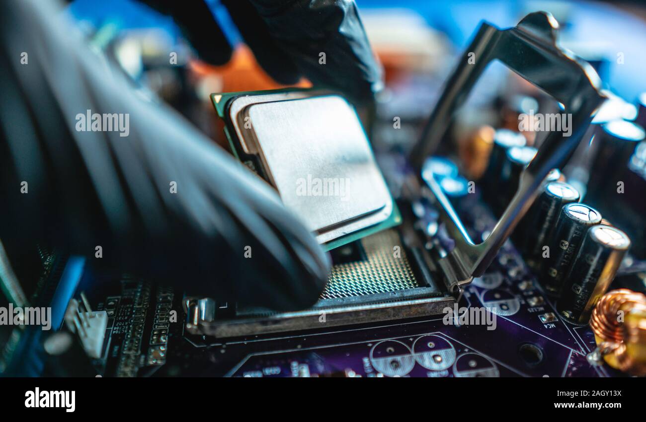 Engineer repairman holding hands in black gloves chip processor, CPU to ...