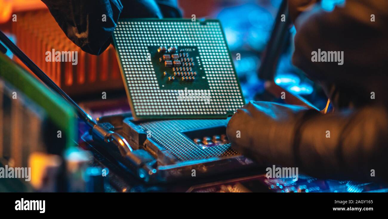 Engineer repairman holding hands in black gloves chip processor, CPU to ...