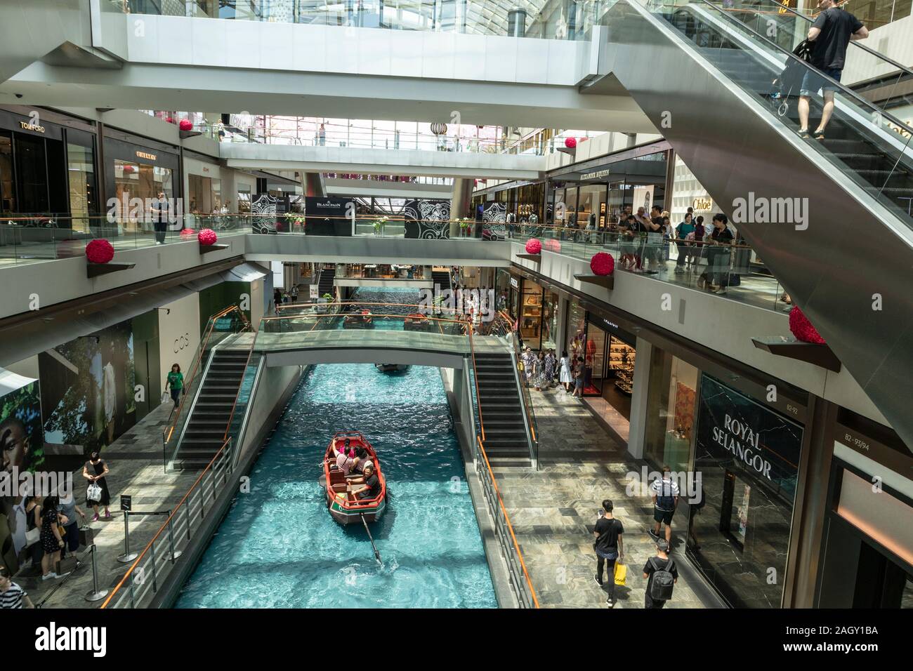 Boats on the canal in the Marina Bay Sands shopping Mall in Singapore ...