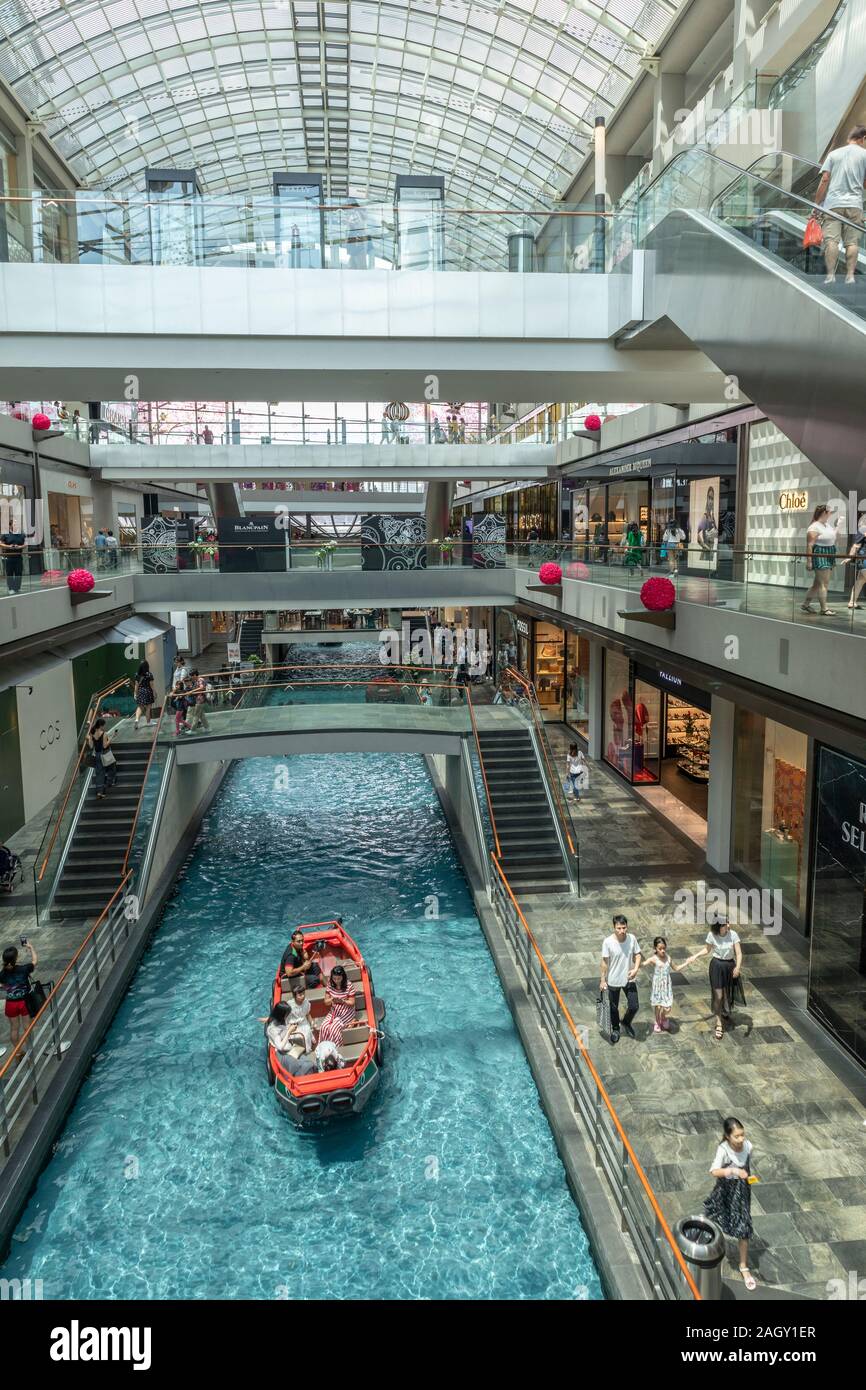 Boats on the canal in the Marina Bay Sands shopping Mall in Singapore ...