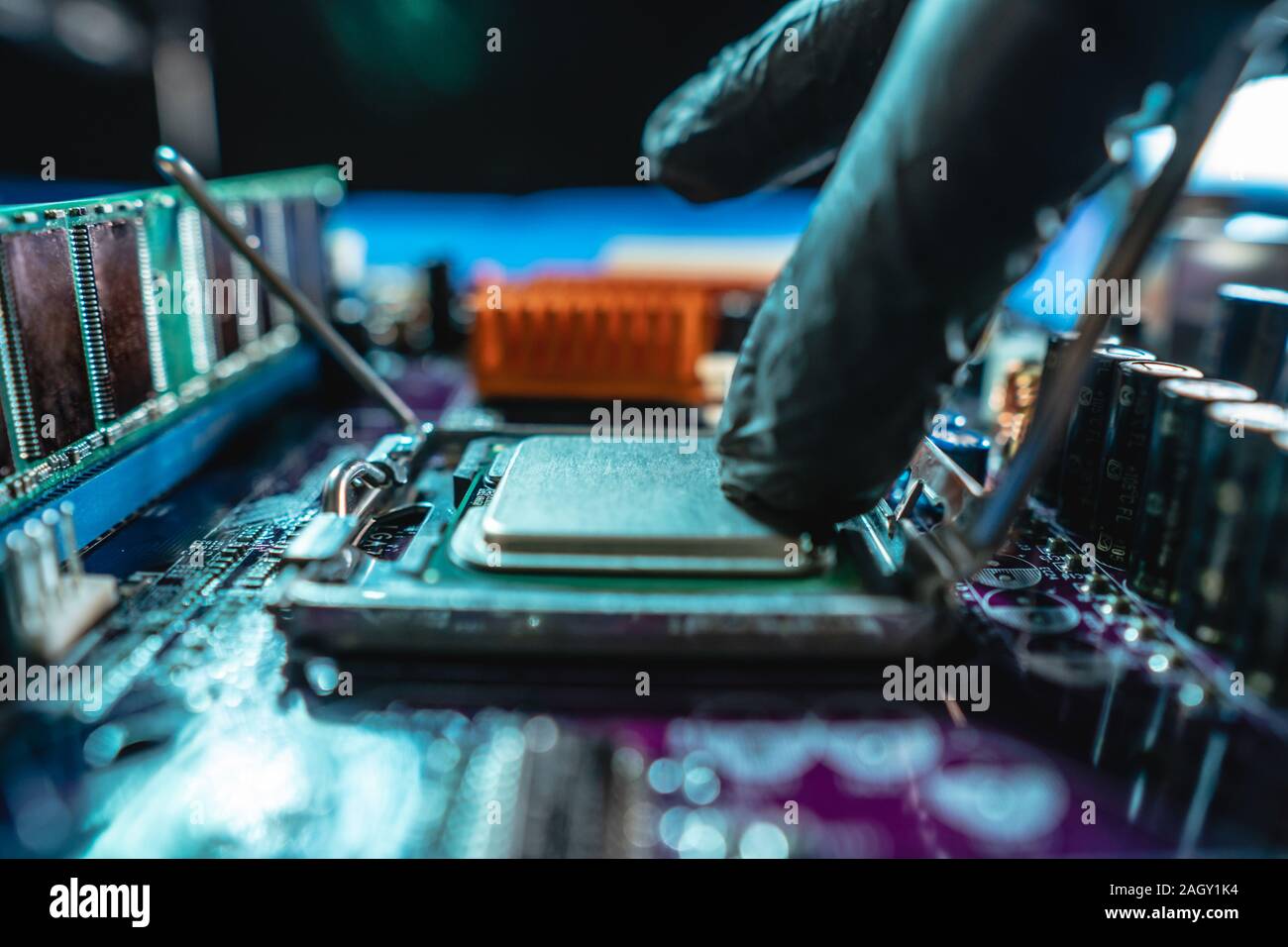 Engineer repairman holding hands in black gloves chip processor, CPU to insert into the socket ...