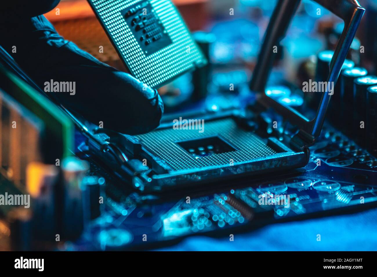 Engineer repairman holding hands in black gloves chip processor, CPU to insert into the socket ...