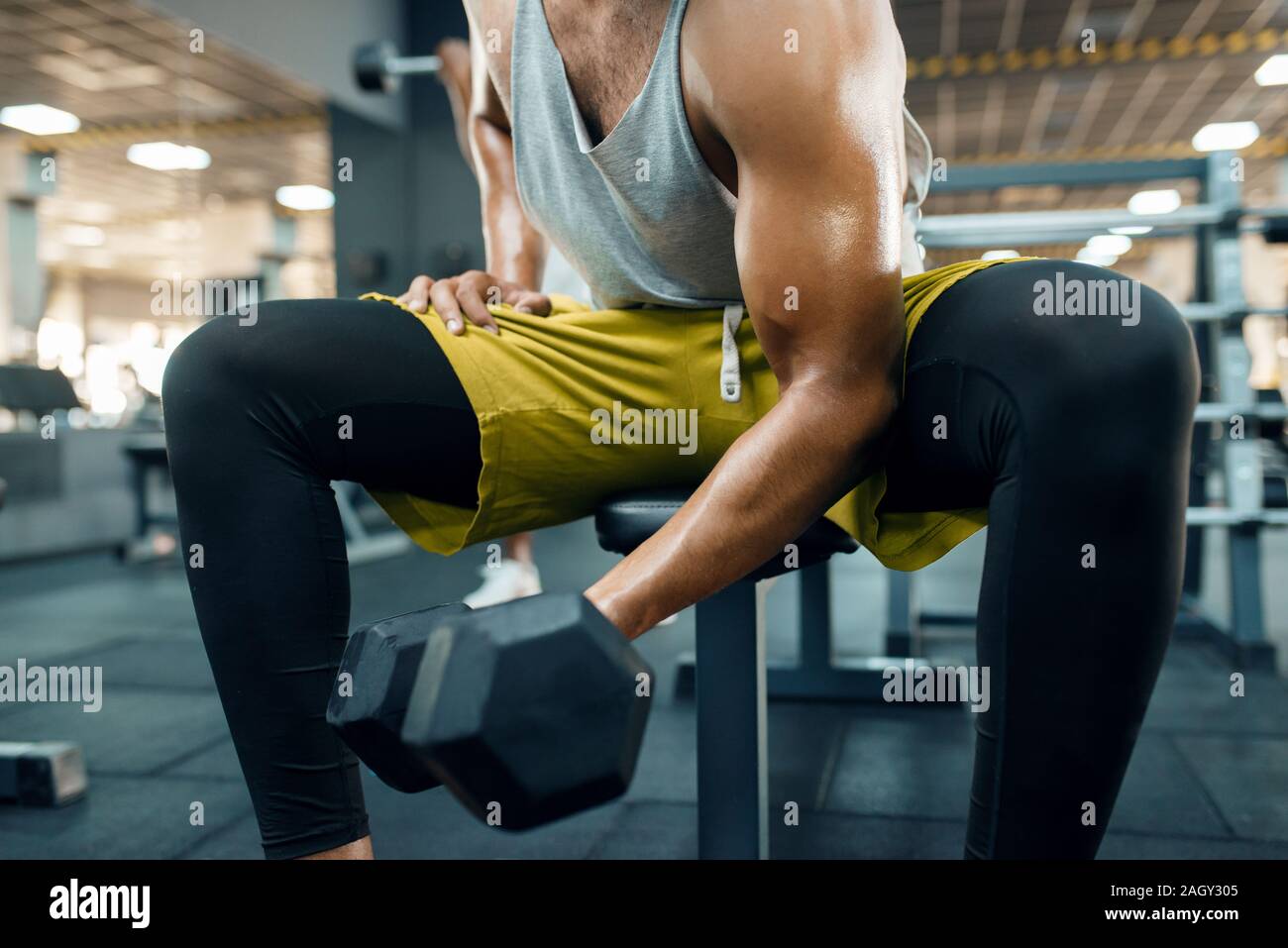 Muscular man doing exercise with heavy dumbbell Stock Photo - Alamy