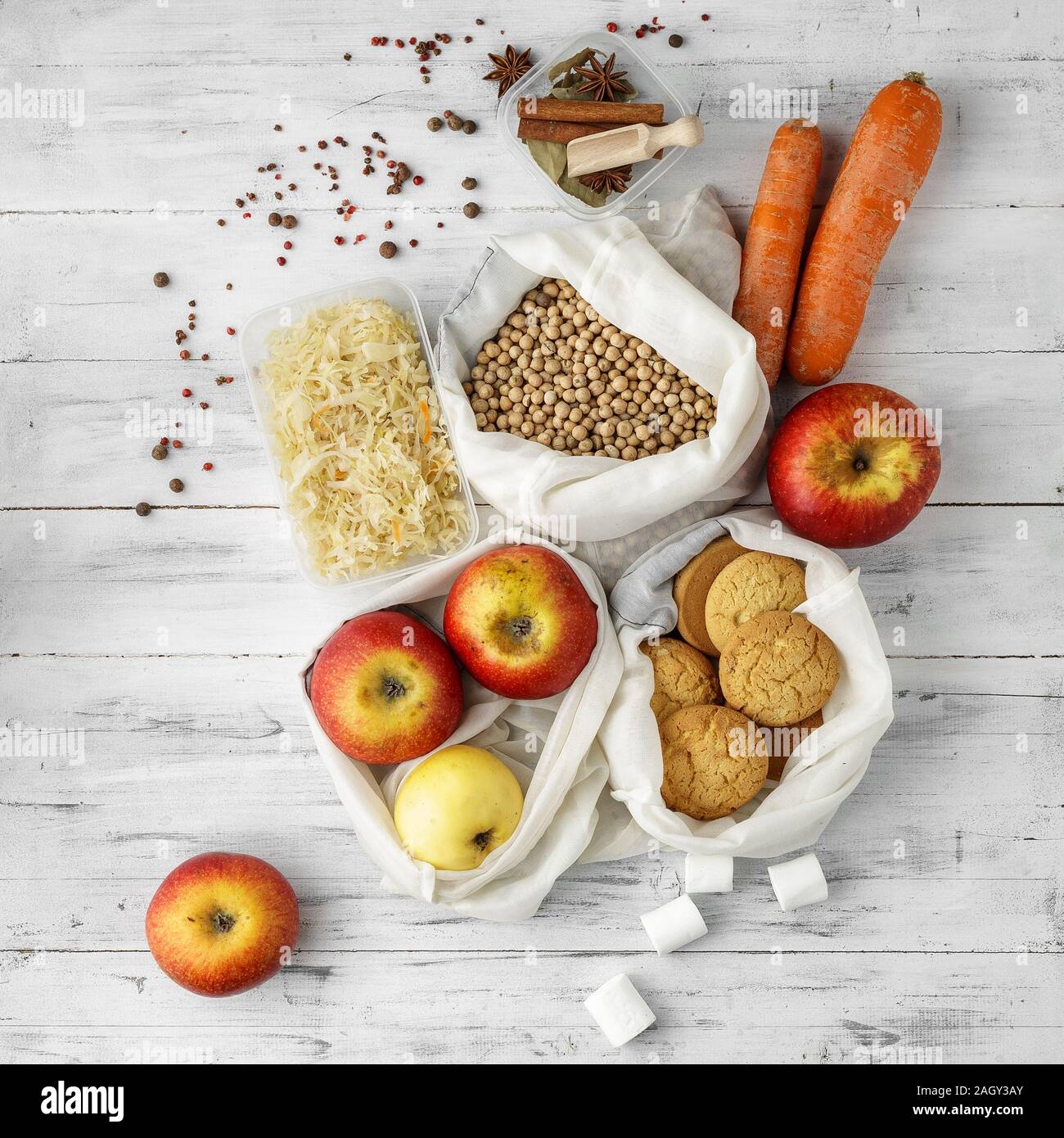 Groceries in reusable eco friendly textile bags, flat lay. Sustainable ...