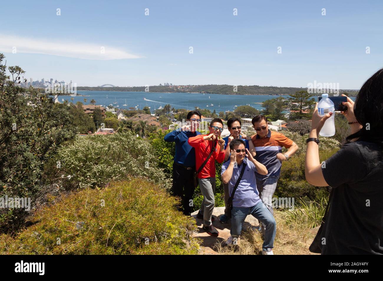 A group of Asian tourists in Australia on holiday posing for a photo ...