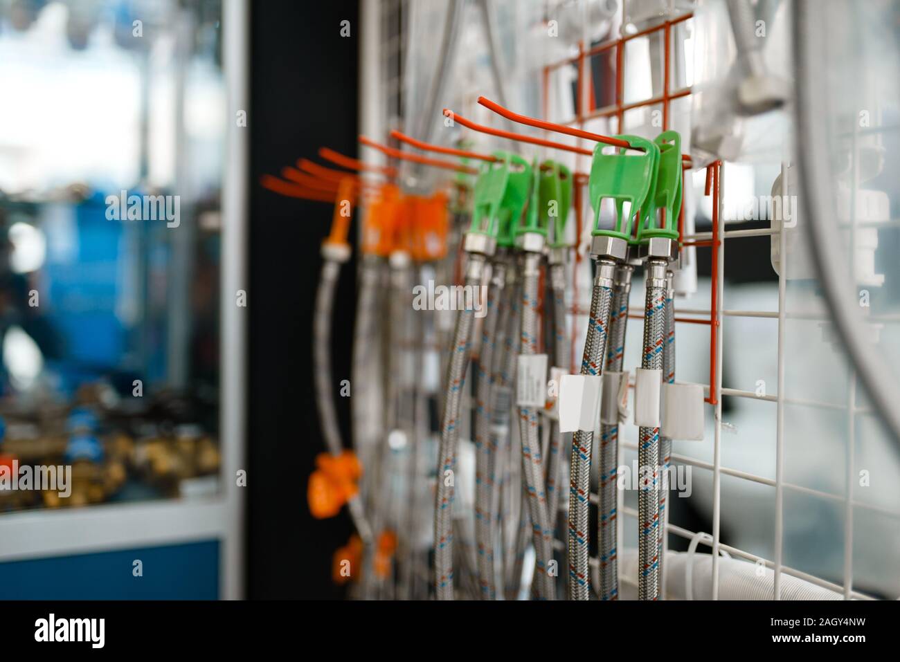 Water supply hoses on showcase, plumbering store Stock Photo - Alamy