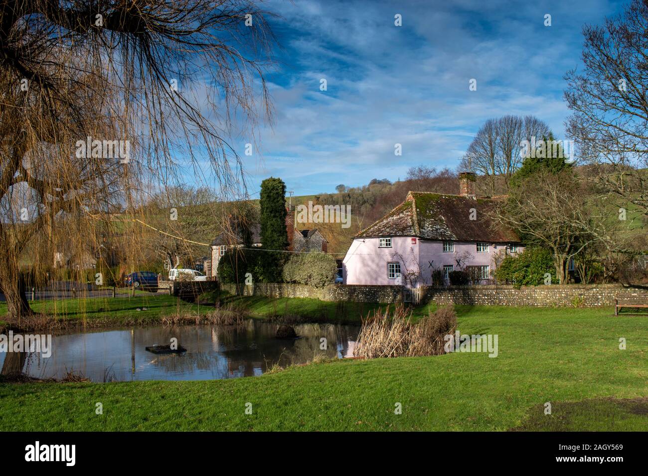 East Dean Village green and pond with reflections of an old English ...
