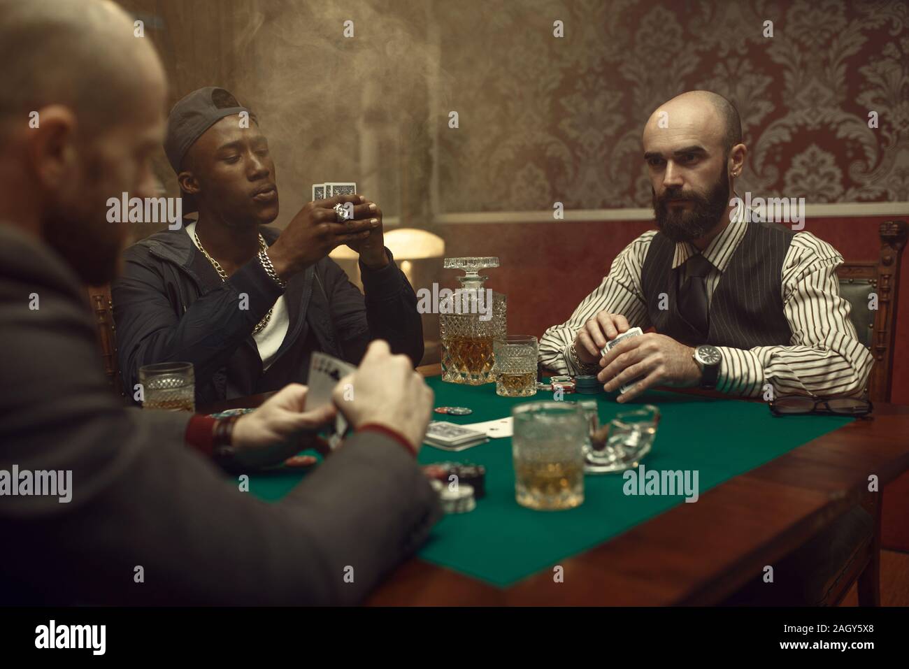 Three men playing cards in hi-res stock photography and images - Alamy