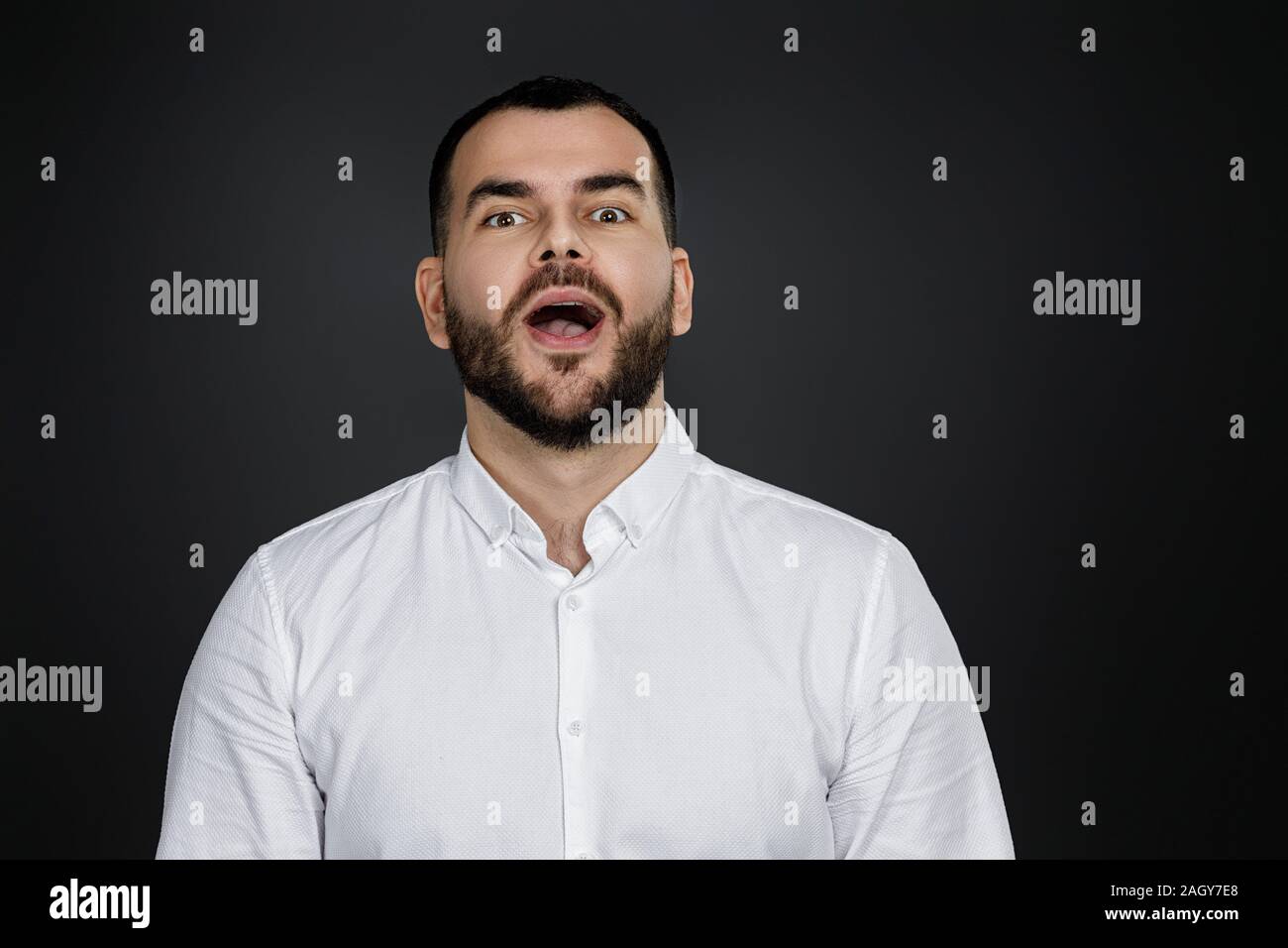 Portrait Of Young Surprised Handsome Bearded Man With Shocked Facial