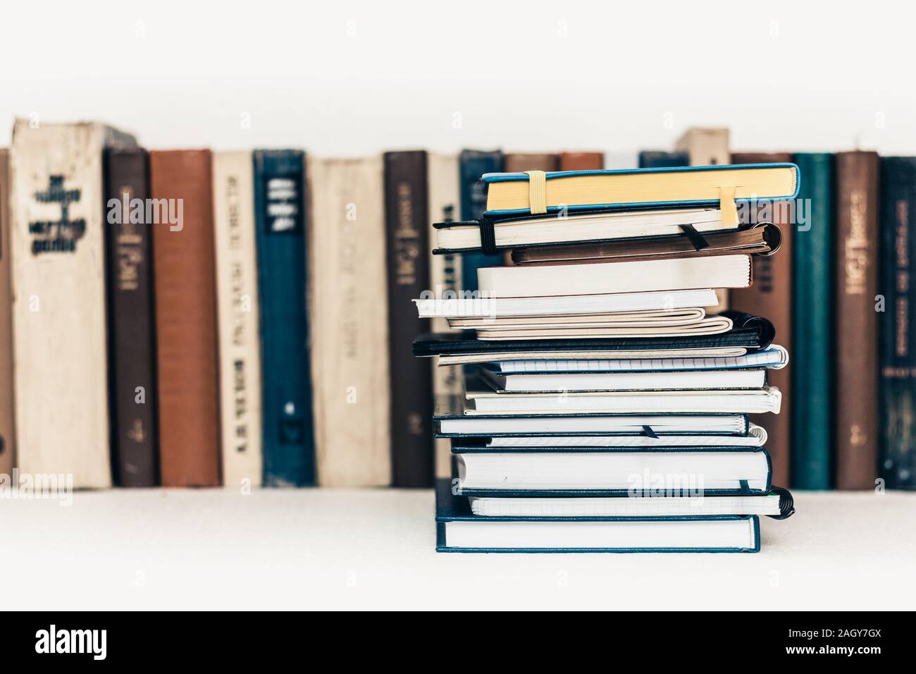 Pile of notebooks, many books and textbooks with copy space for text ...