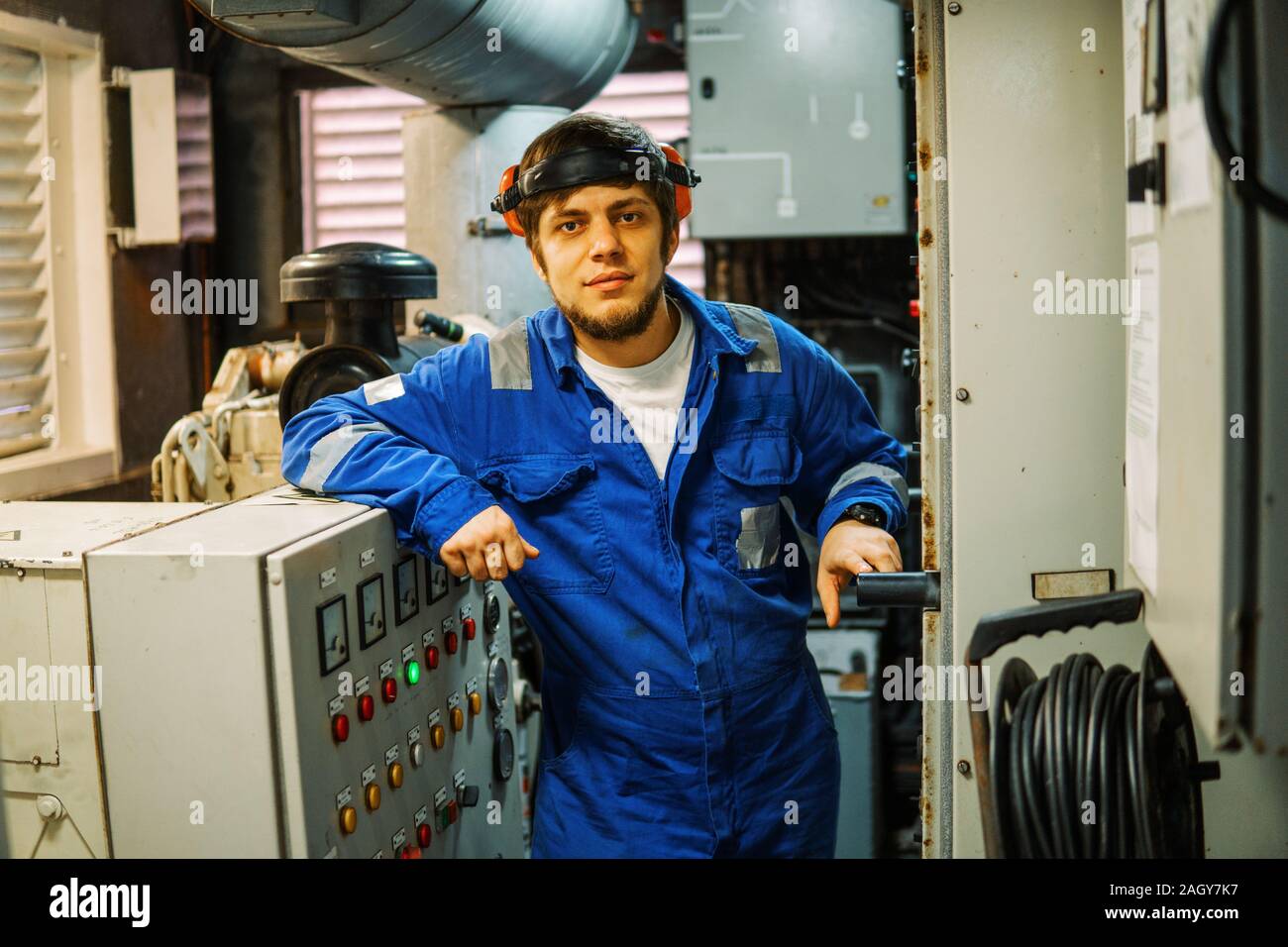 Marine engineer inspecting ship's engine or generators Stock Photo - Alamy