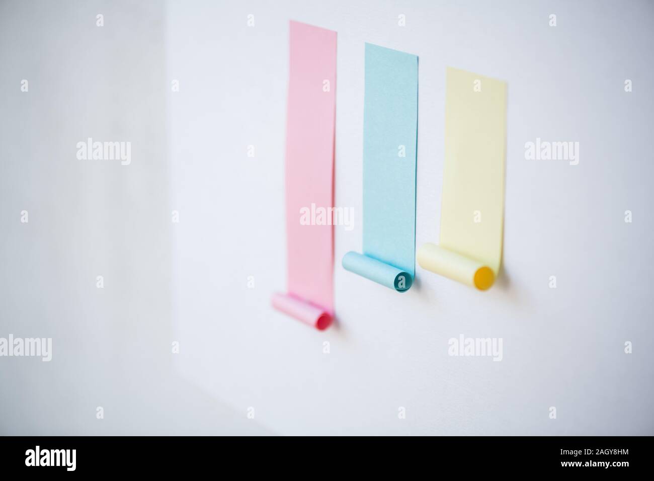 Colorful chart made up of blank pink and smaller blue and yellow sticky ...