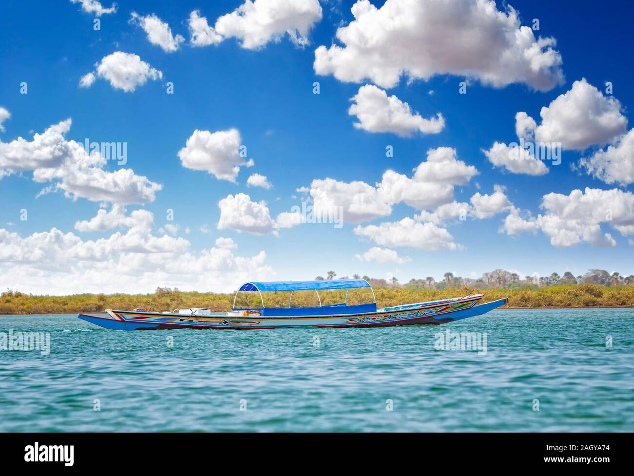 Traditional colorful wooden boat on the river in sea lagoon and a ...