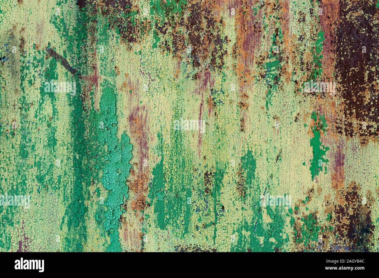 Old metal rusted green-yellow sheet with bounced, cracked paint ...
