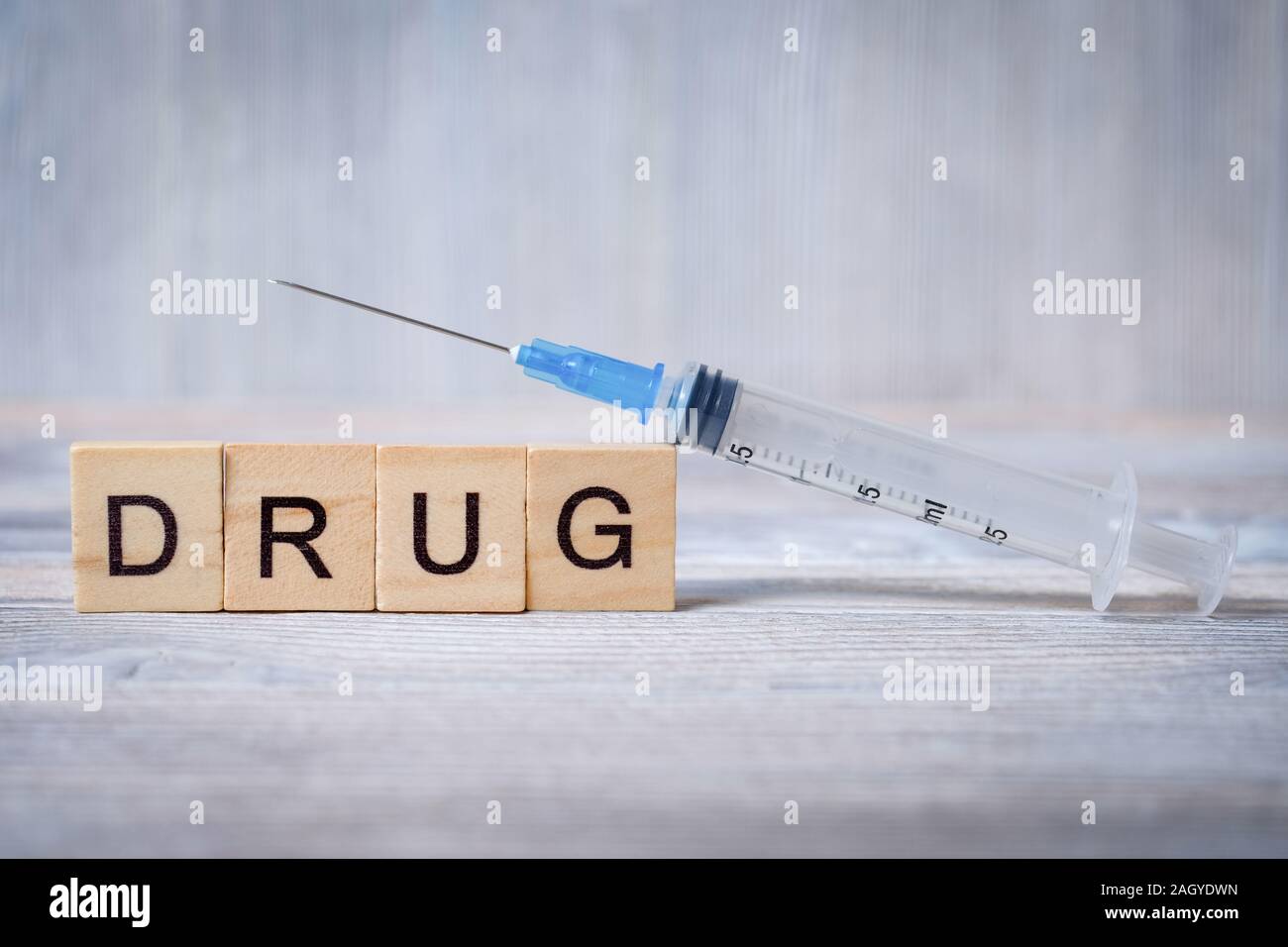 A syringe for drugs on wooden cubes with letters. Close up Stock Photo ...