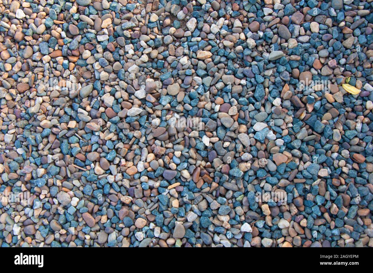 Blue, grey, brown and white different small rocks, stones or gravel ...