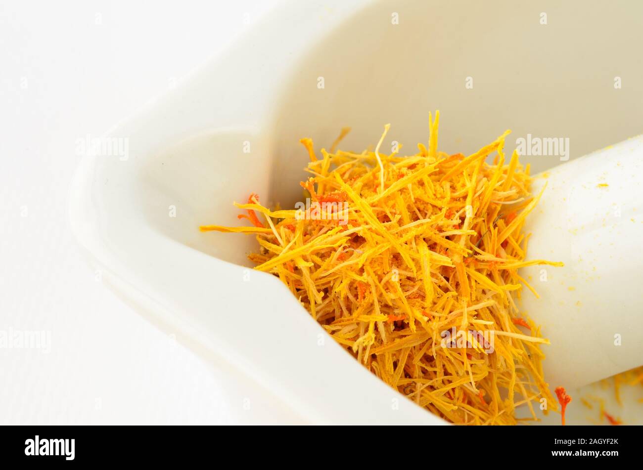 Close up view of saffron, tasty and costly spice in porcelain mortar ...