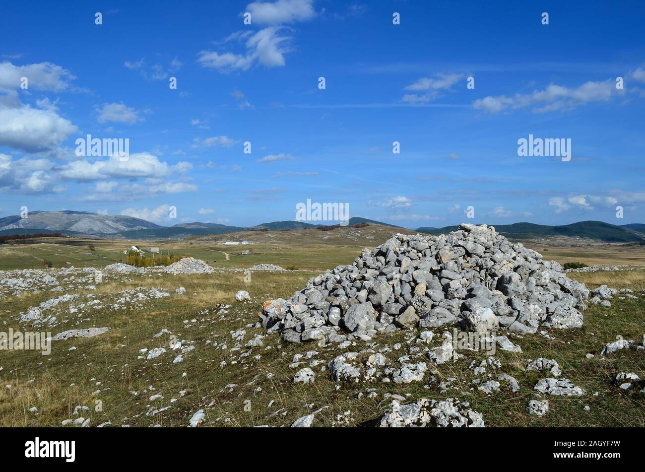 Mountain landscape with big pile of rocks in foreground Stock Photo - Alamy