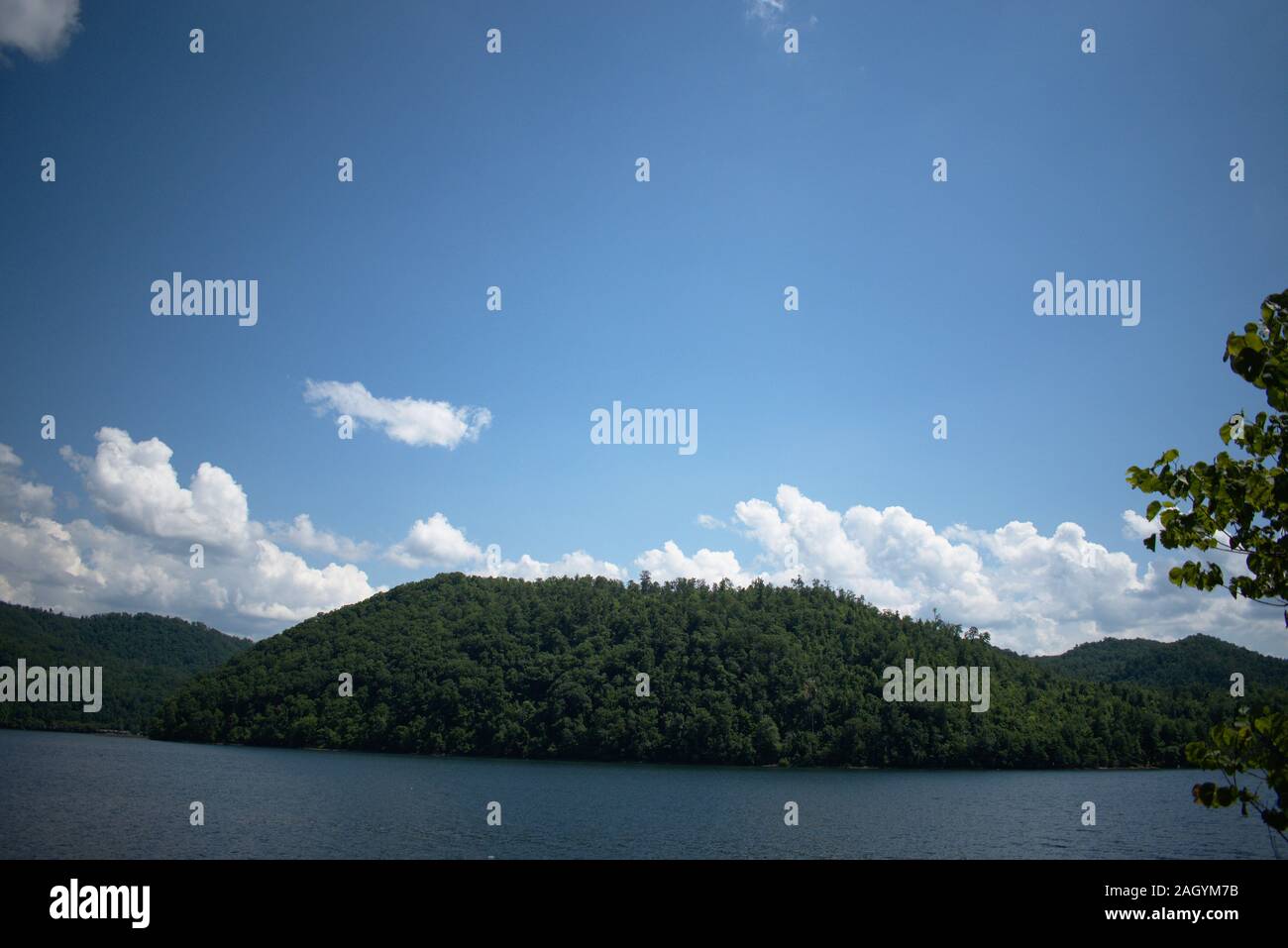 Beautiful lake with blue sky background Stock Photo - Alamy