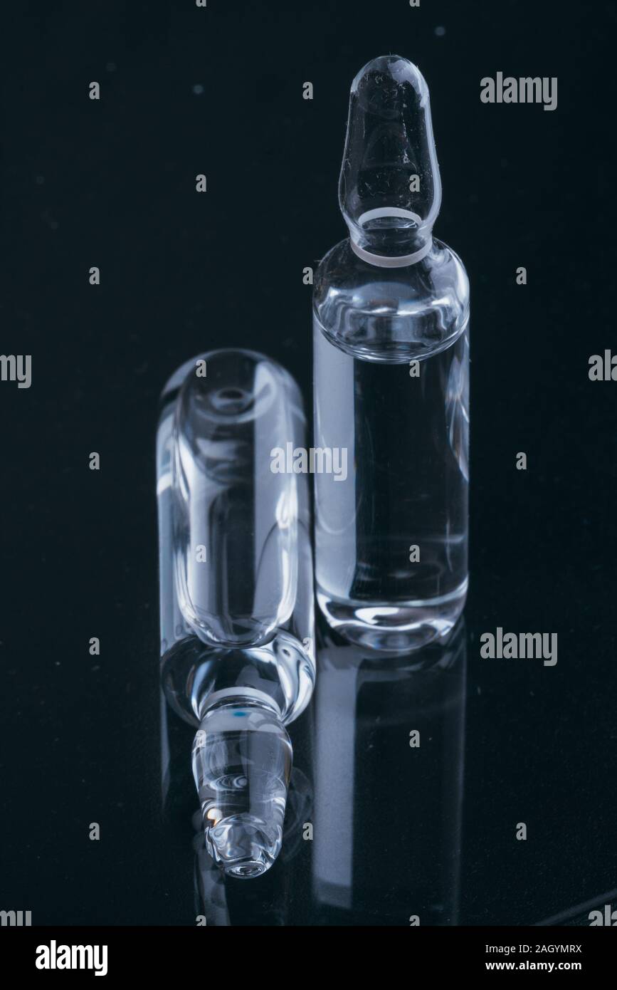 Glass medical ampoule vial for injection. Medicine is dry white drug ...