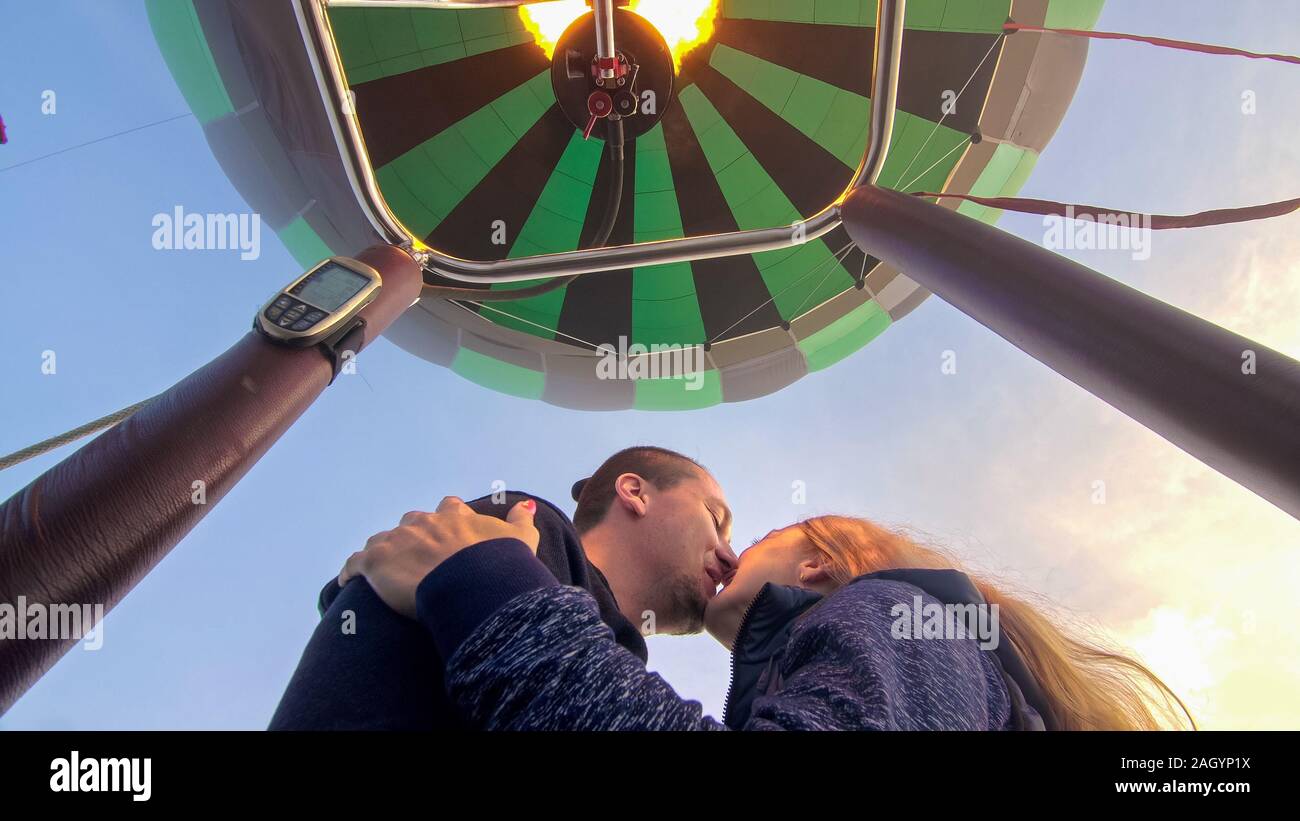 Adventure love couple on hot air balloon watermelon. Man and woman kiss ...