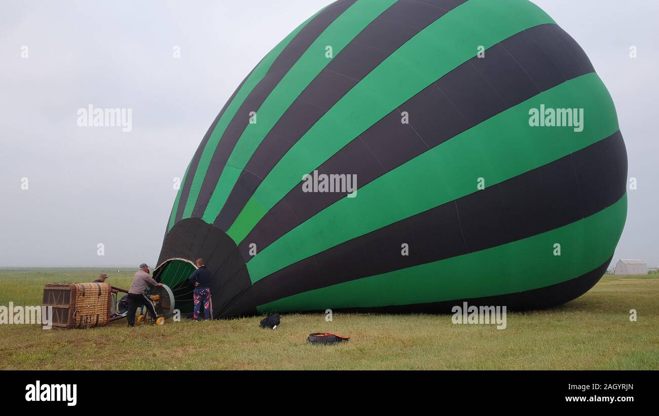 Inflating, unpack and flying up hot air balloon watermelon. Burner ...