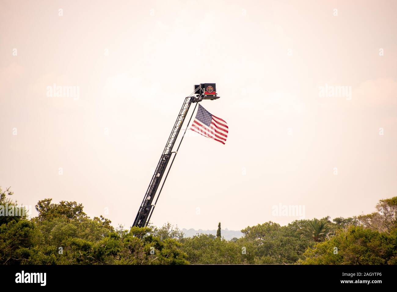 The Flag of the United States of America hanging off a firetruck ladder ...