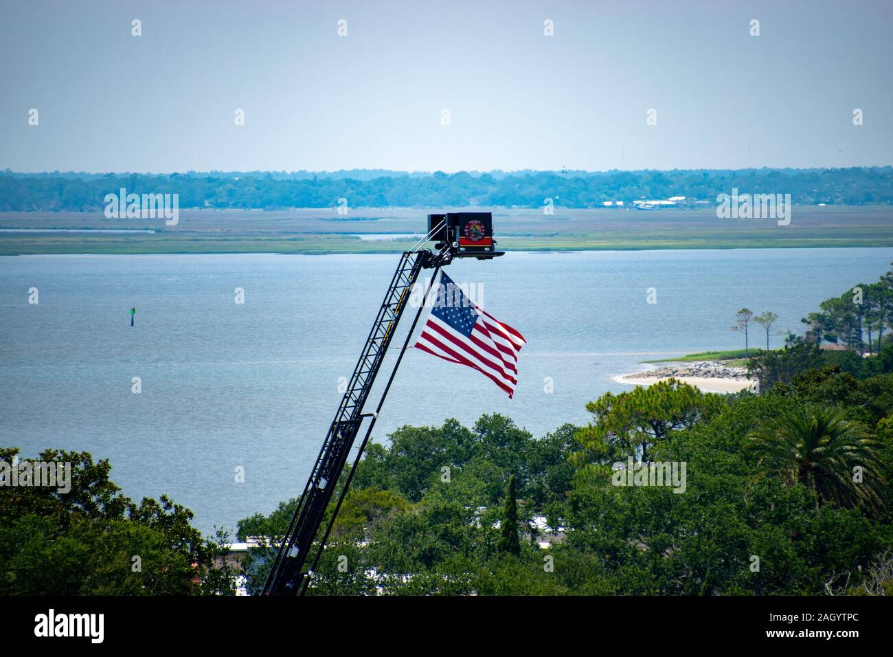 The Flag of the United States of America hanging off a firetruck ladder ...