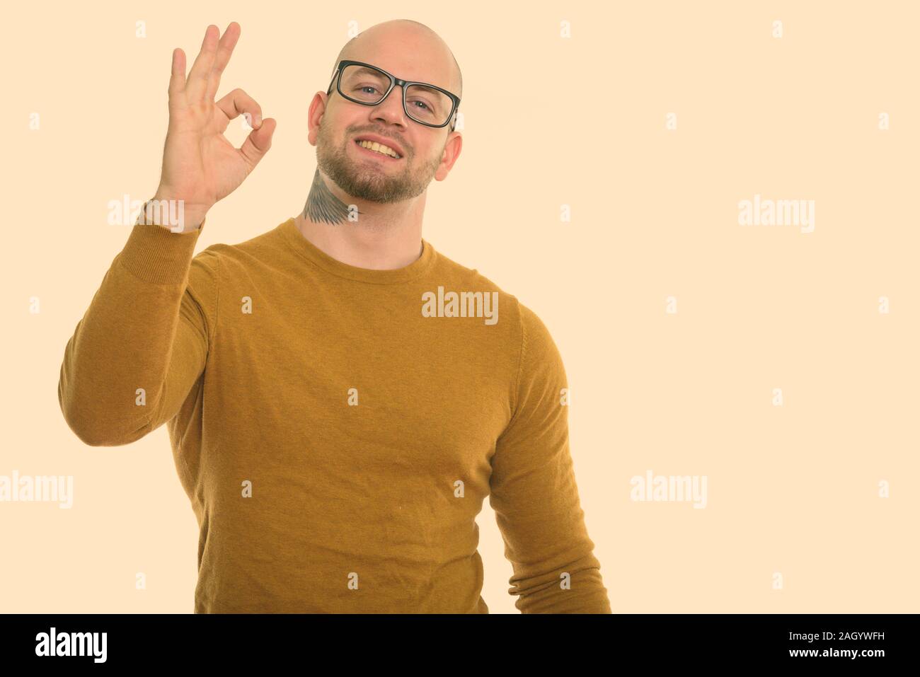 Young happy bald muscular man smiling while giving ok sign Stock Photo ...
