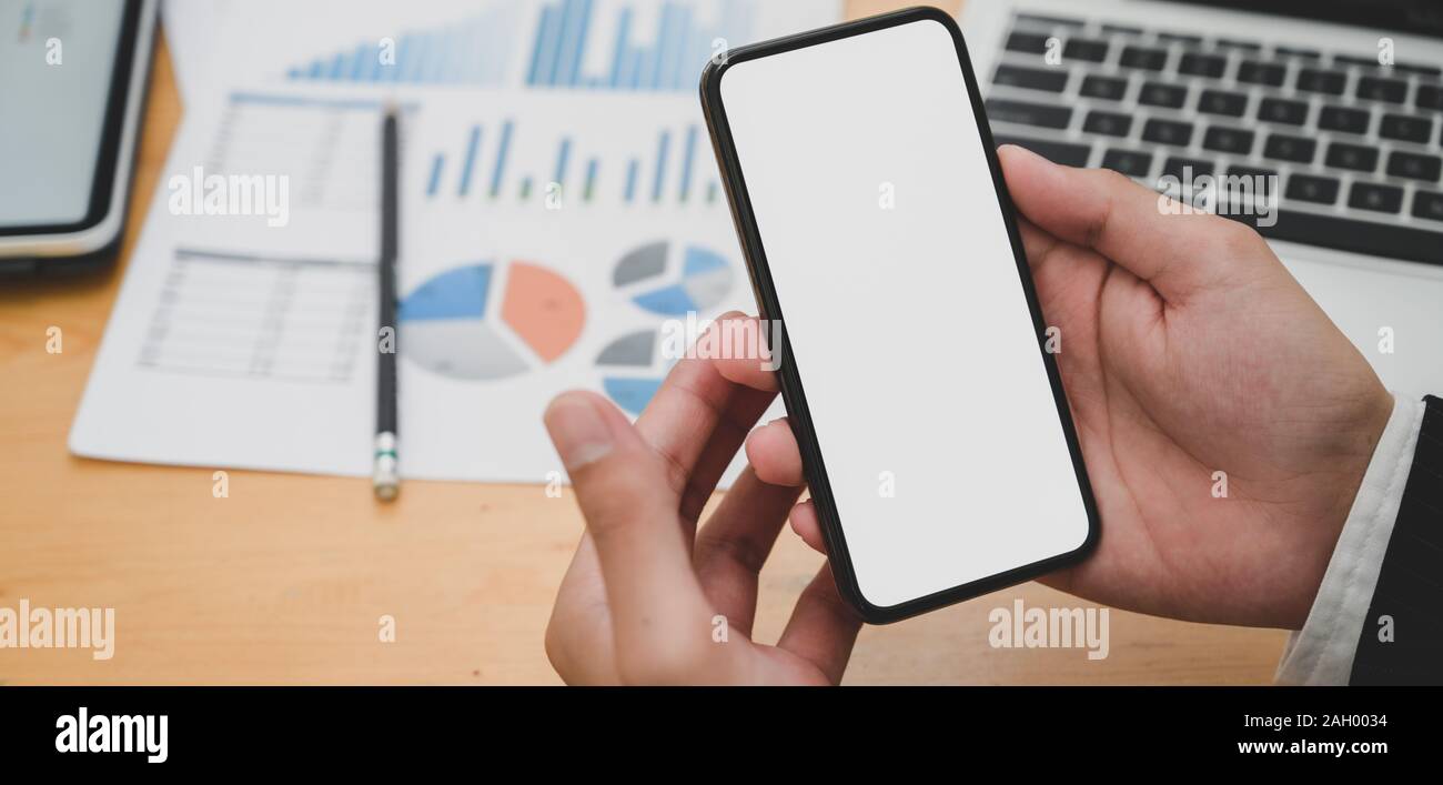 Cropped shot of young businessman working on his project while using ...