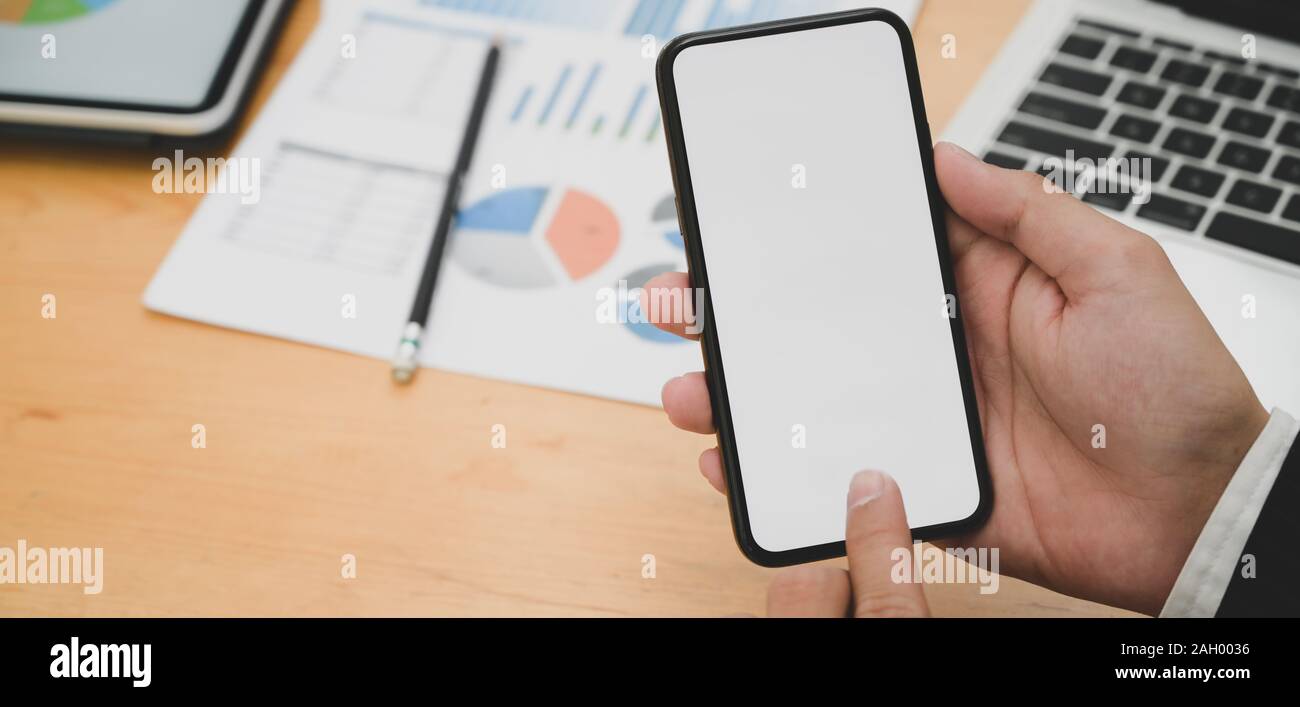 Cropped shot of young businessman working on his project while using ...