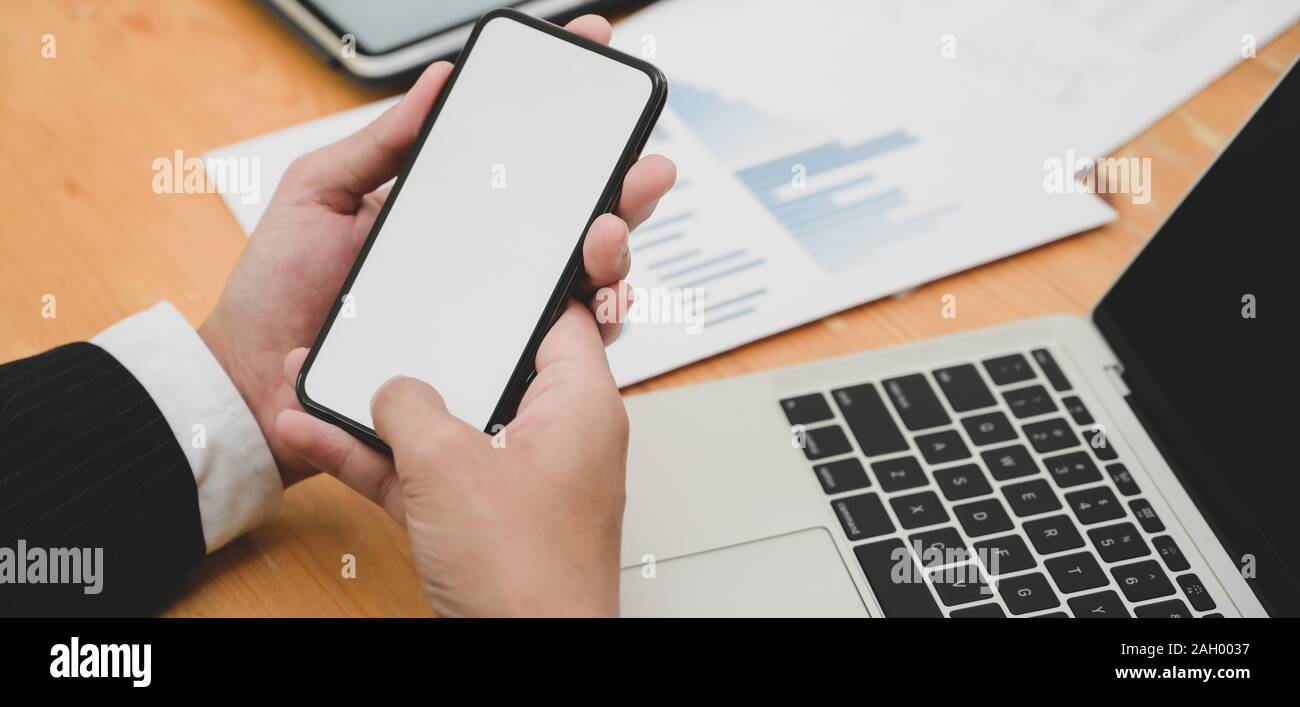 Cropped shot of young businessman working on his project while using ...