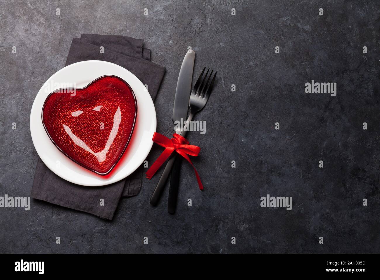 Valentines day or romantic dinner table setting over stone background. Top view flat lay with ...