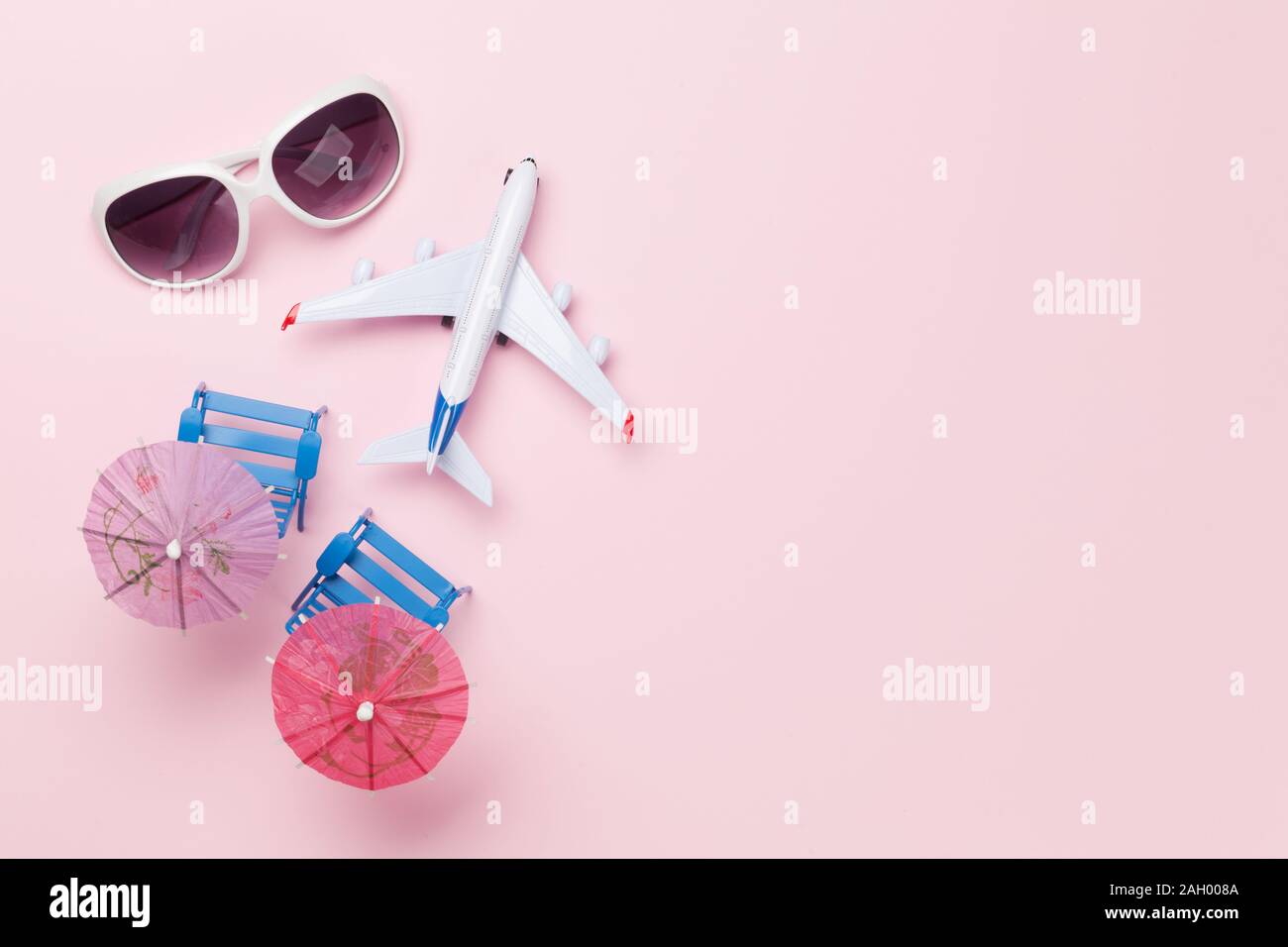 Travel concept with airplane toy, beach chairs and glasses. Top view ...