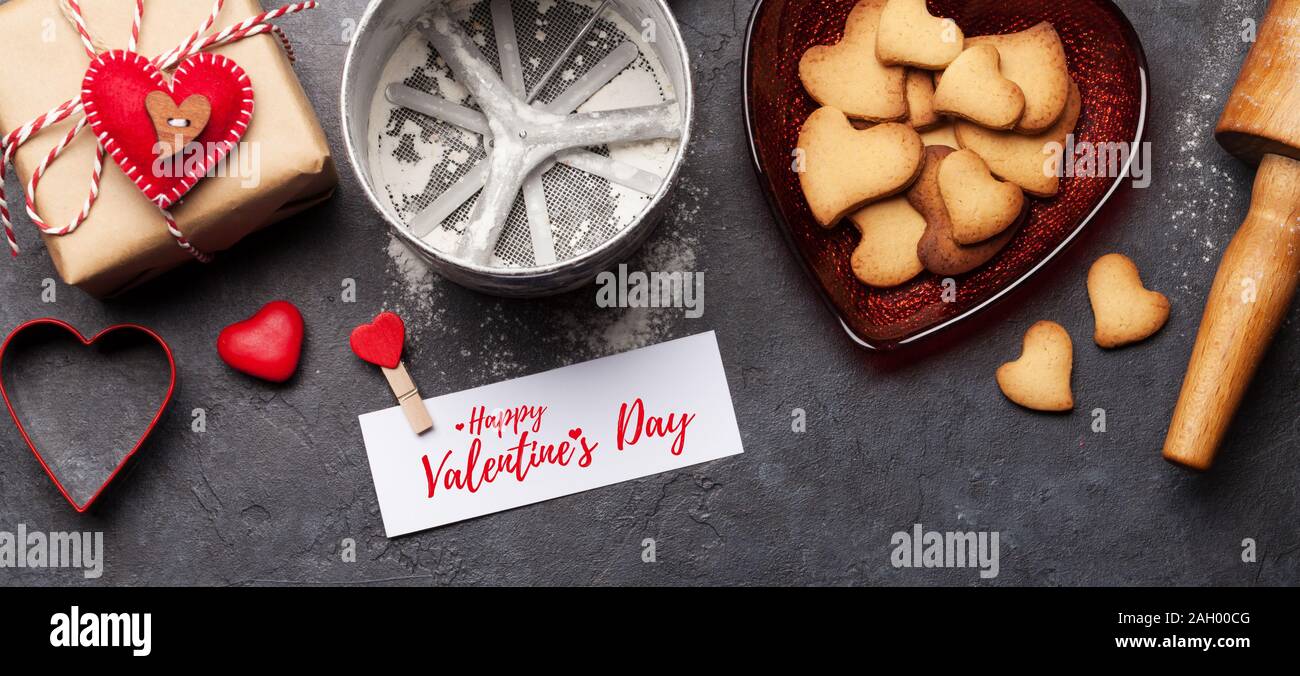 Valentines day gift box and heart shaped gingerbread cookies over stone ...