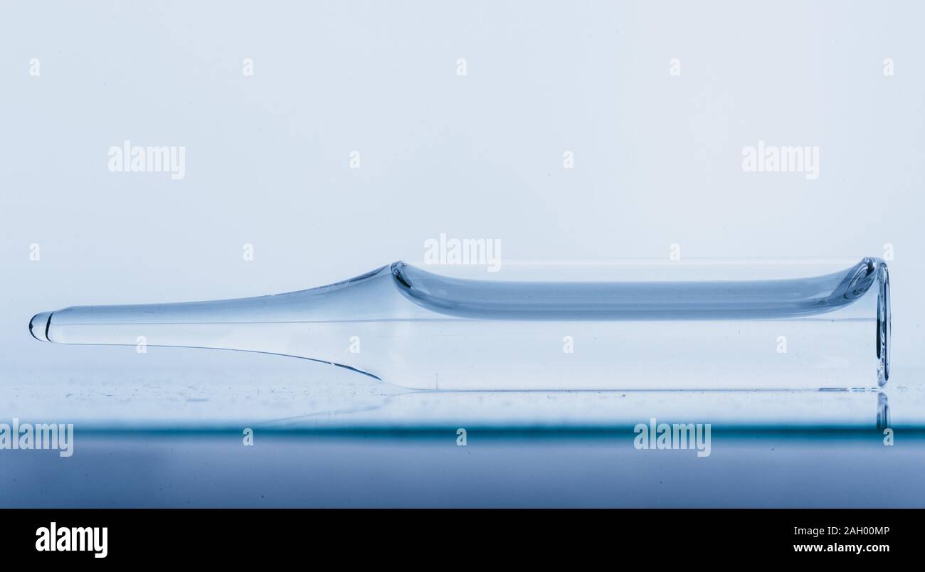 Glass medical ampoule vial for injection. Medicine is dry white drug ...